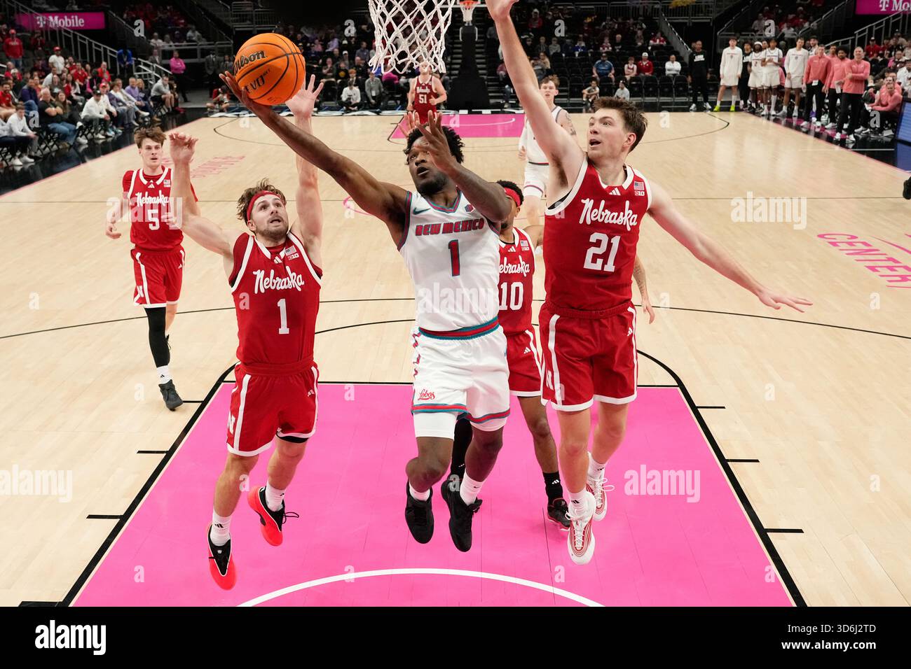 New Mexico guard Deyton Albury, center, shoots under pressure from ...