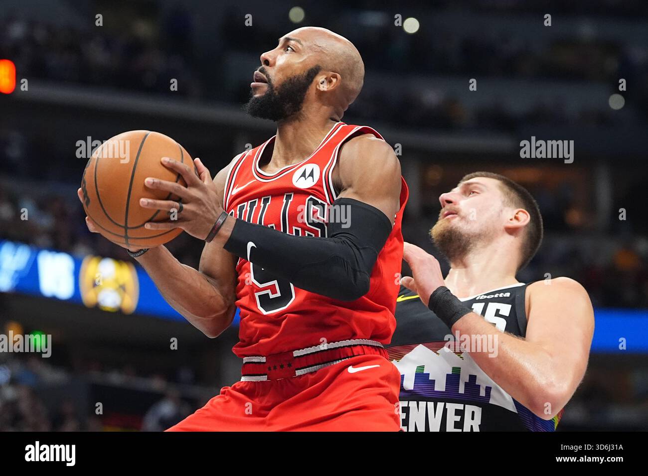 Chicago Bulls guard Jevon Carter (5) and Denver Nuggets center Nikola ...