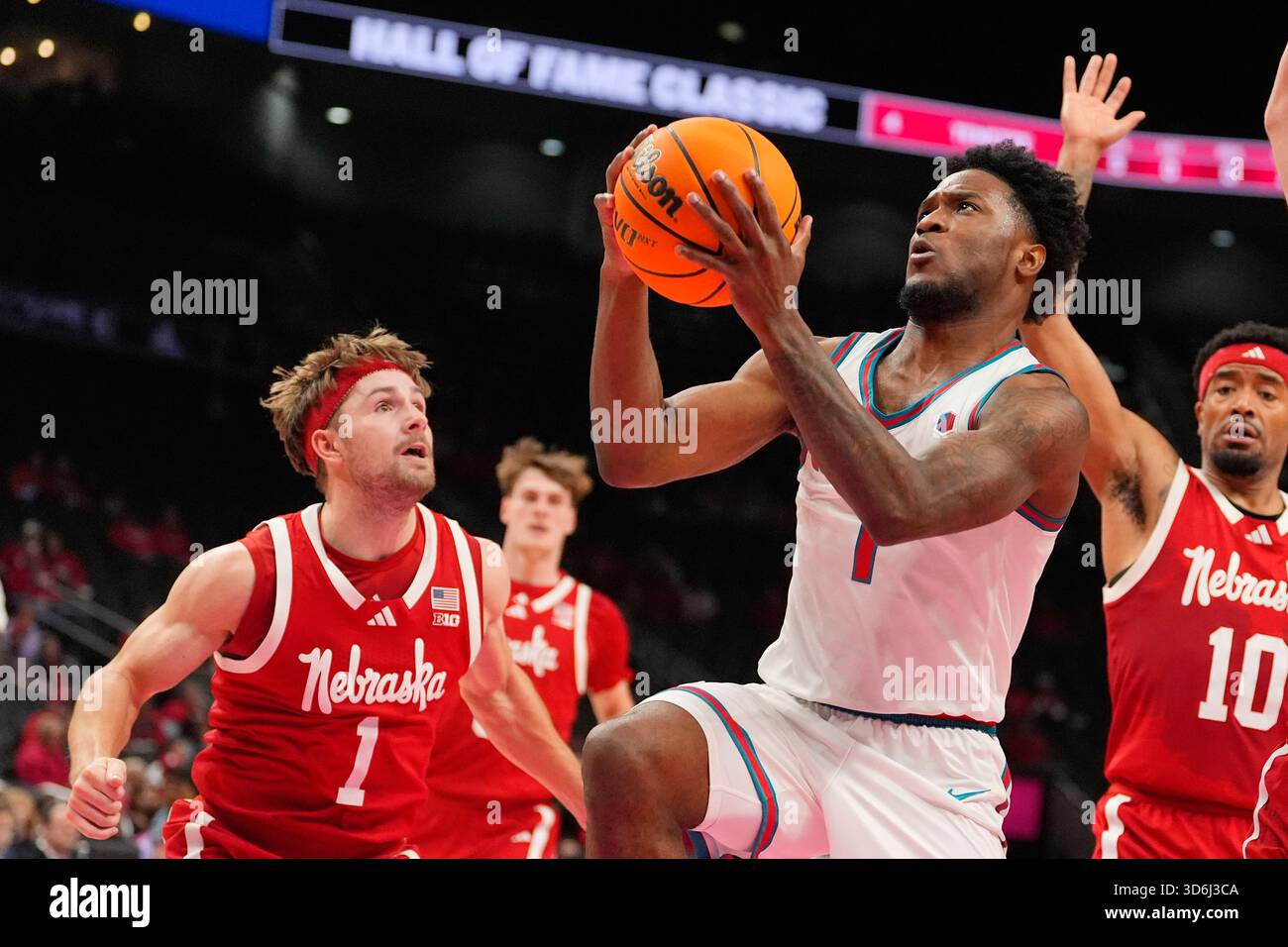 New Mexico guard Deyton Albury shoots over Nebraska guard Sam Hoiberg ...
