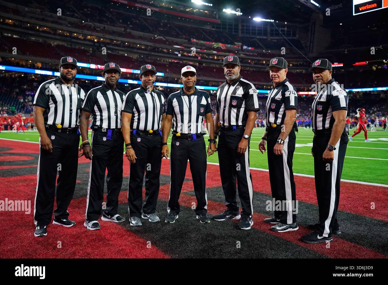 Game officials pose for a group photo, from left, field judge Tra Boger ...