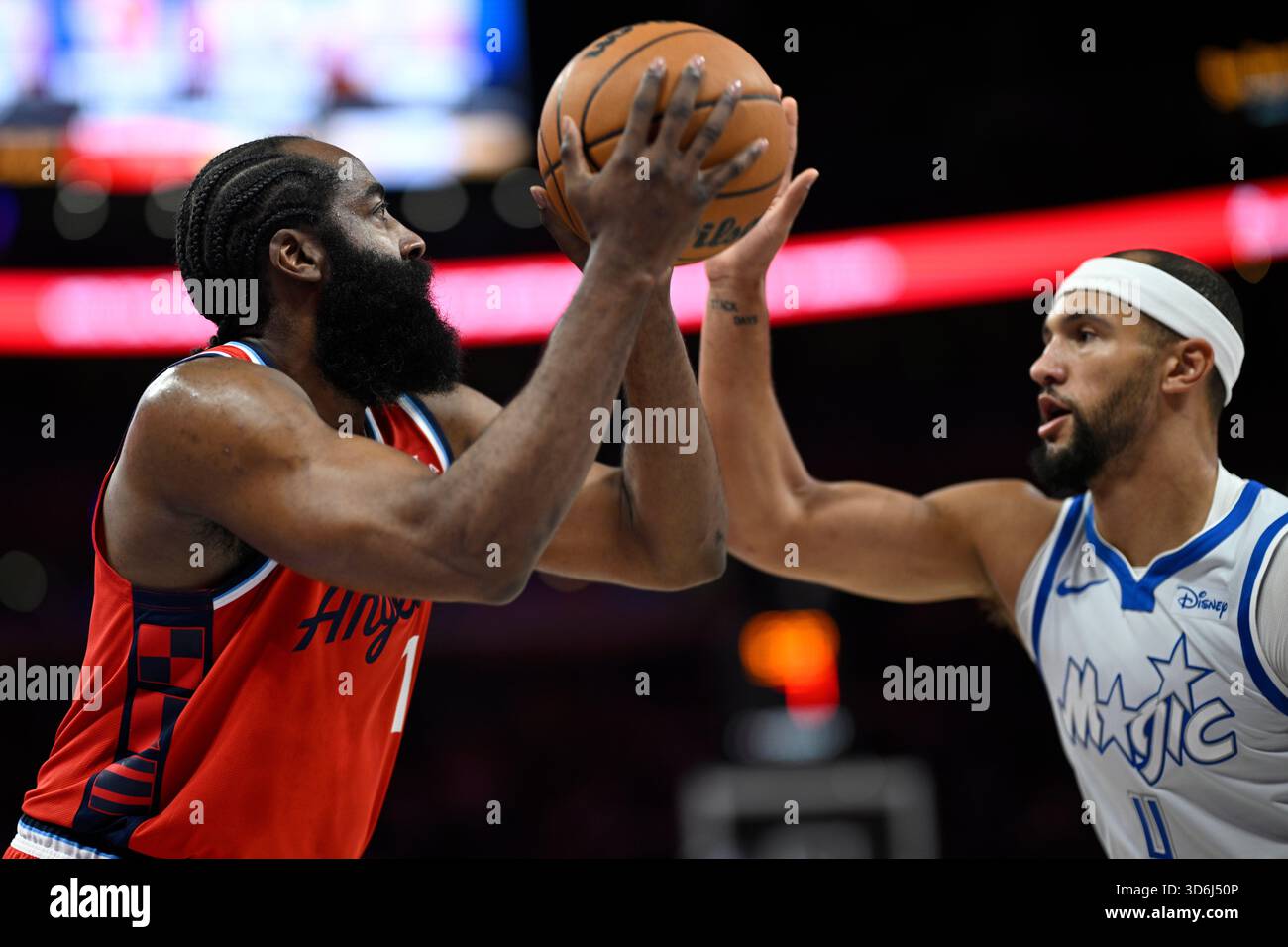 Los Angeles Clippers guard James Harden (1) goes up to shoot in front ...