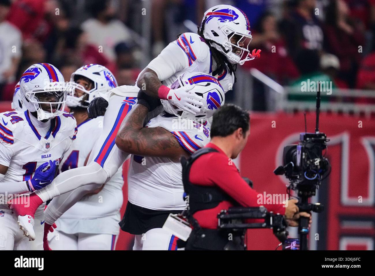 Buffalo Bills running back James Cook III, top, is lifted by Dion ...
