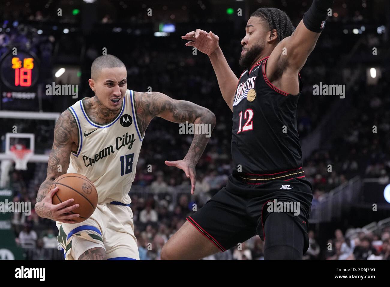 Milwaukee Bucks' Kyle Kuzma tries to get by Philadelphia 76ers' Trendon ...