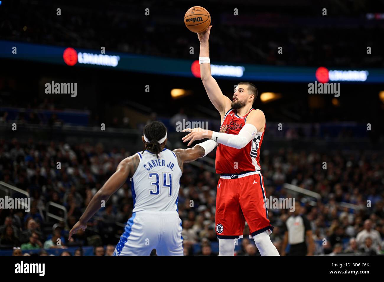Los Angeles Clippers center Ivica Zubac, right, shoots over Orlando ...