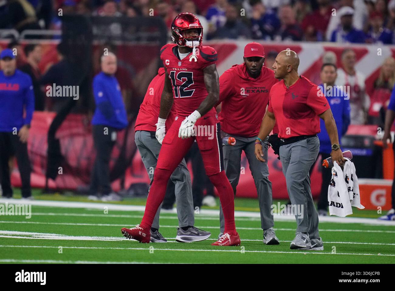 Houston Texans' Nico Collins (12) walks off the field with medical ...