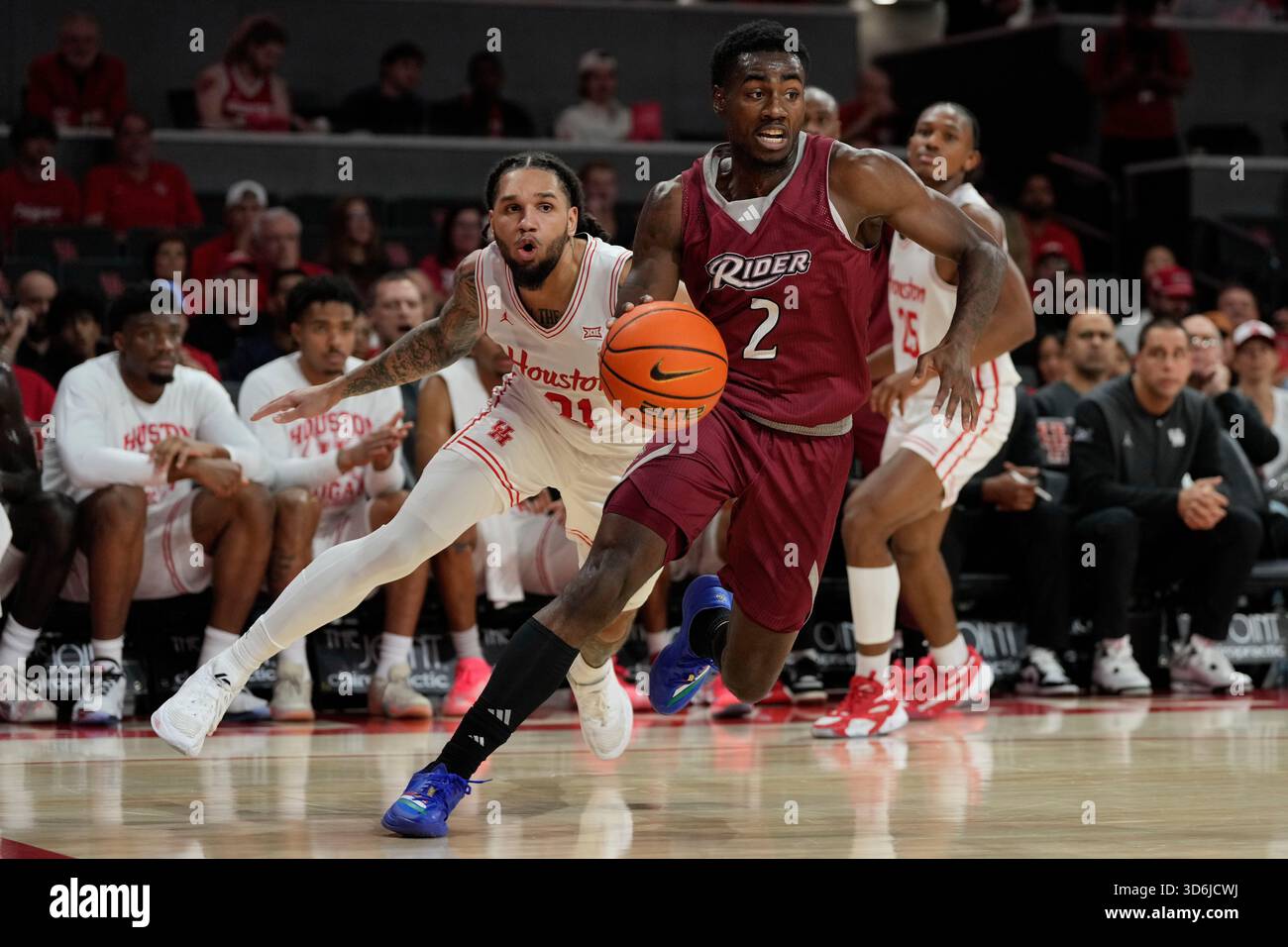 Rider guard Caleb Smith (2) drives past Houston guard Emanuel Sharp (21 ...