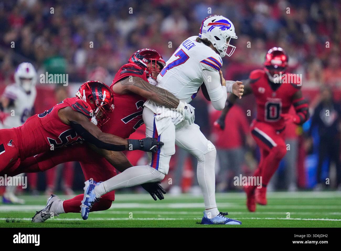 Houston Texans' Danielle Hunter, left, and Tommy Togiai, center, sack ...