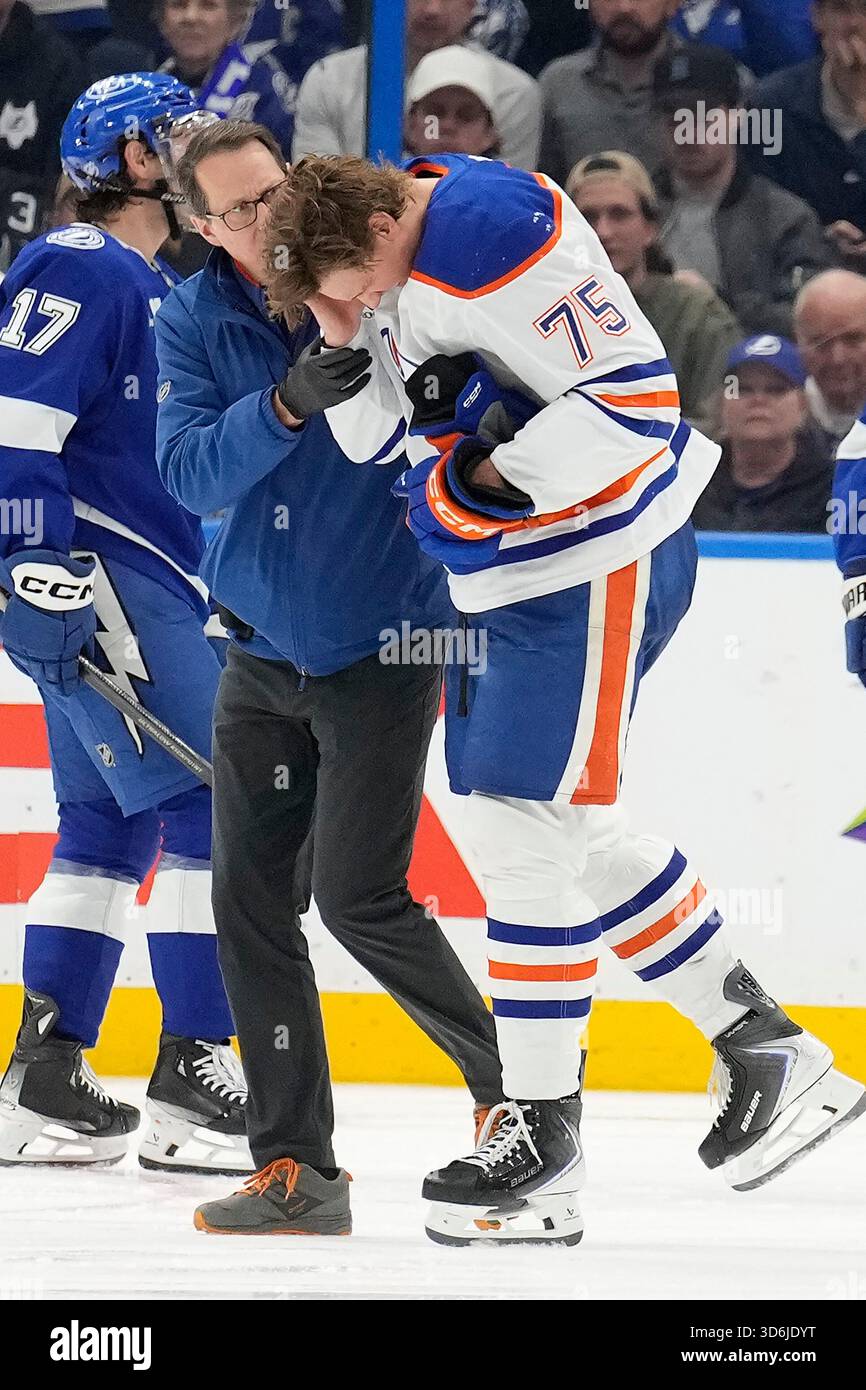 Edmonton Oilers defenseman Alec Regula (75) is helped off the ice after ...
