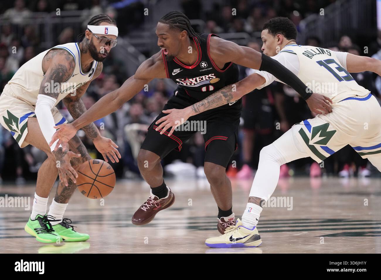 Philadelphia 76ers' Tyrese Maxey tries to drive between Milwaukee Bucks ...