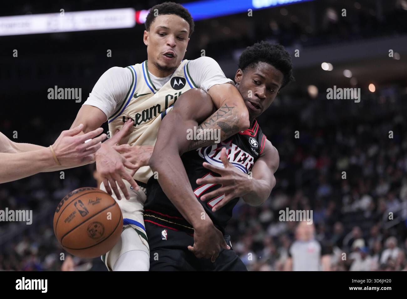 Philadelphia 76ers' VJ Edgecombe and Milwaukee Bucks' Ryan Rollins go ...