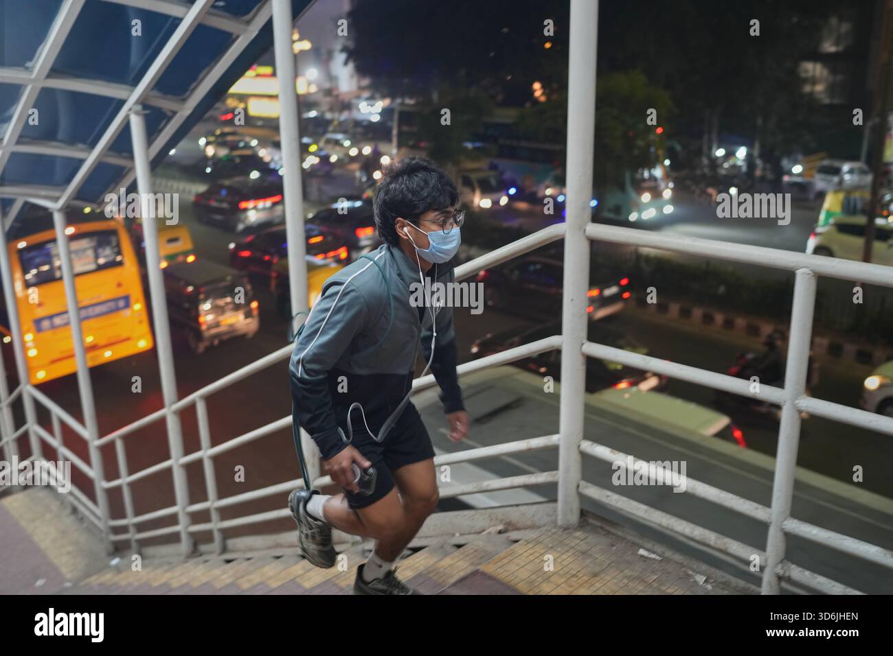 A person crosses an overbridge in New Delhi, India, Tuesday, Nov. 18 ...