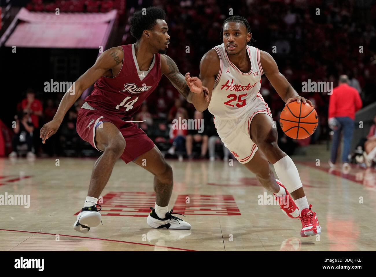 Houston guard Mercy Miller (25) drives around Rider guard Antwan Wilson ...