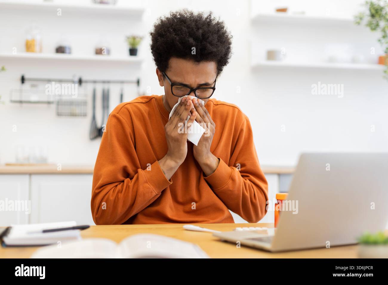 Sick young african man sneezing hi-res stock photography and images - Alamy