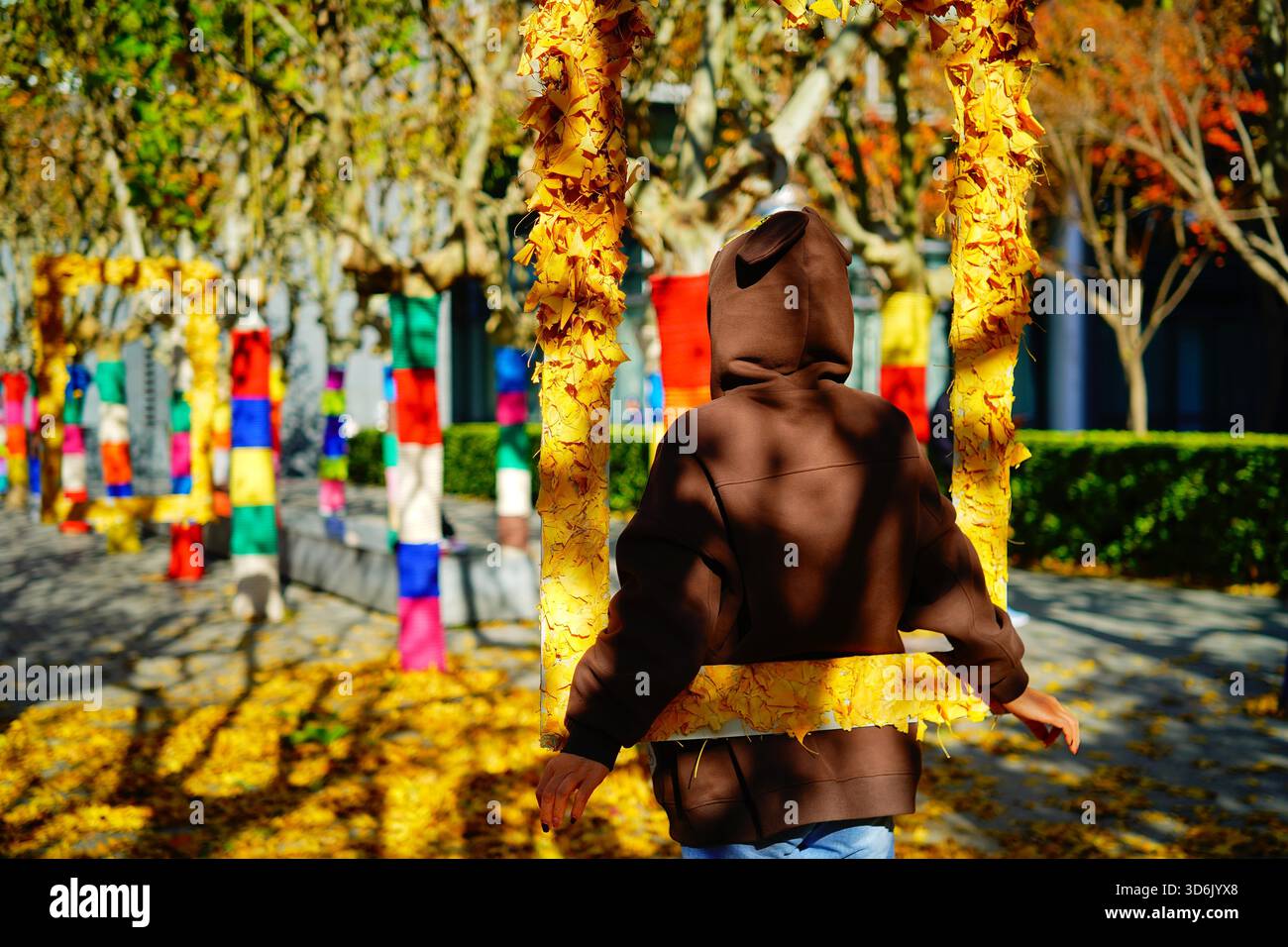 Trees on the street are put on brightly colored "sweaters" for winter ...