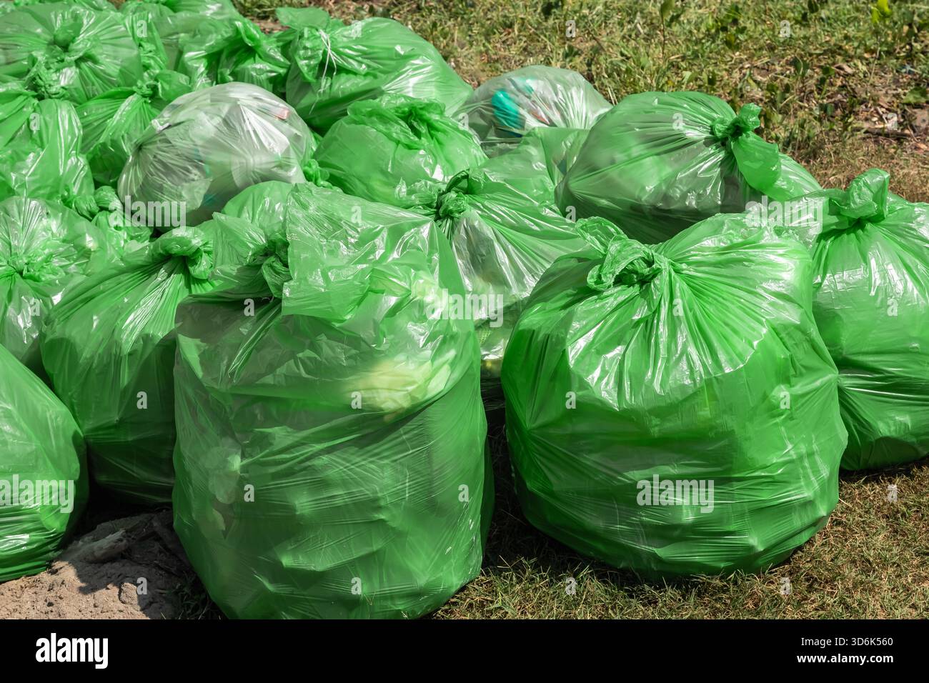 Collected trash in the bags. Cleaning the beach. Plastic bags full of ...