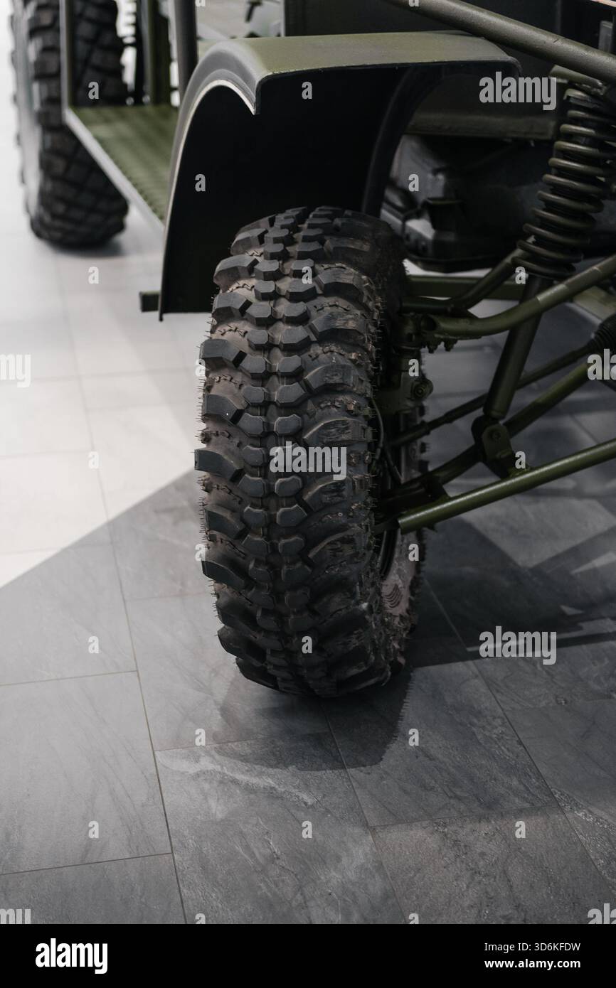 Front wheel of all-terrain vehicle. Olive-colored car buggy with ...