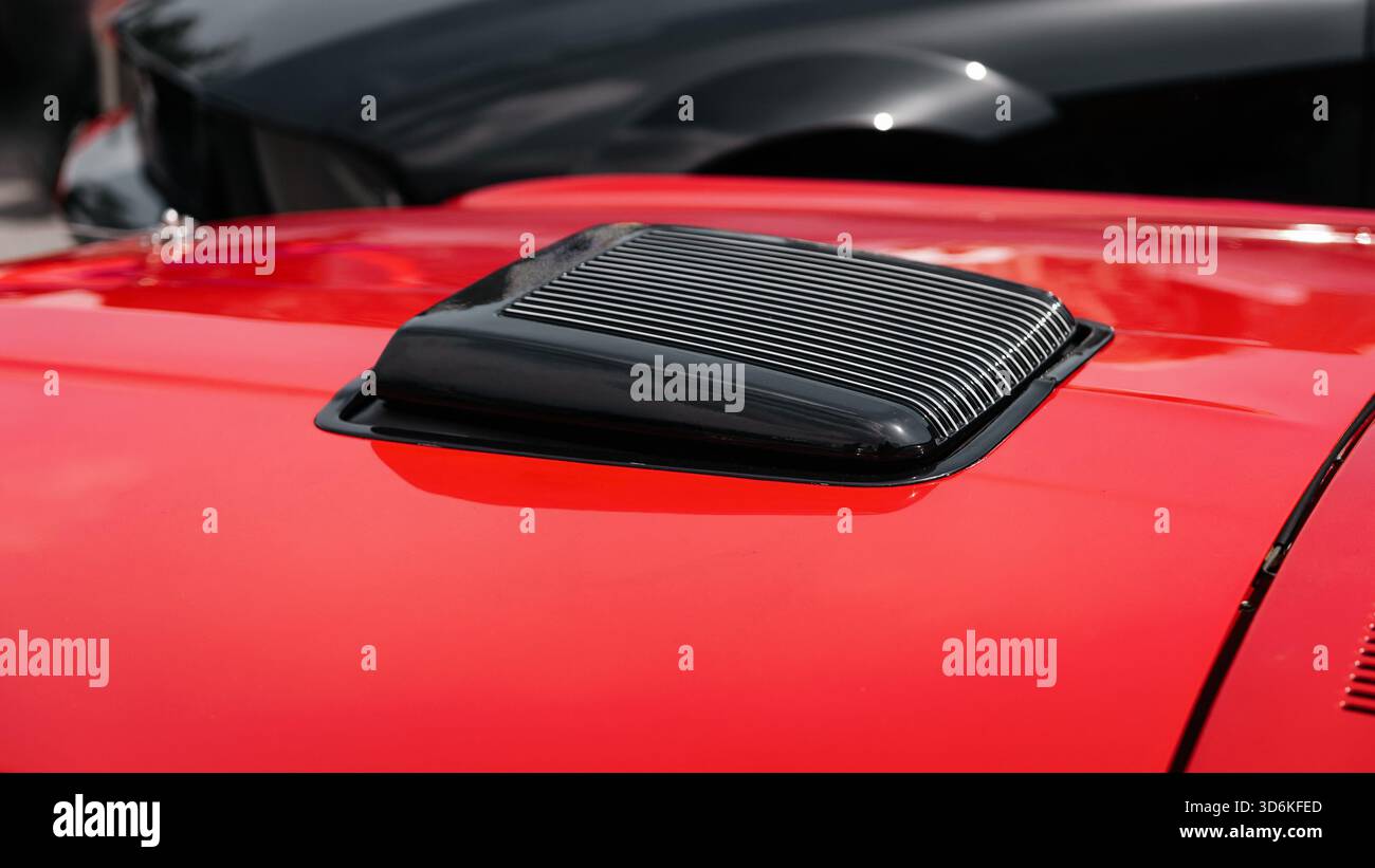 Red 1960s car with shaker scoop. Powerful muscle car with air intake ...