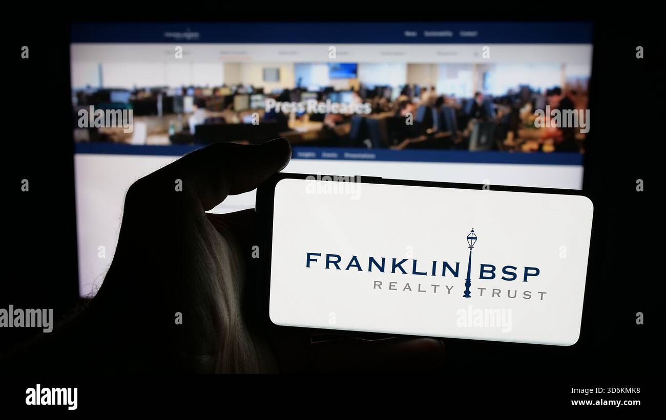 In this photo illustration, a person is holding a mobile phone with the ...