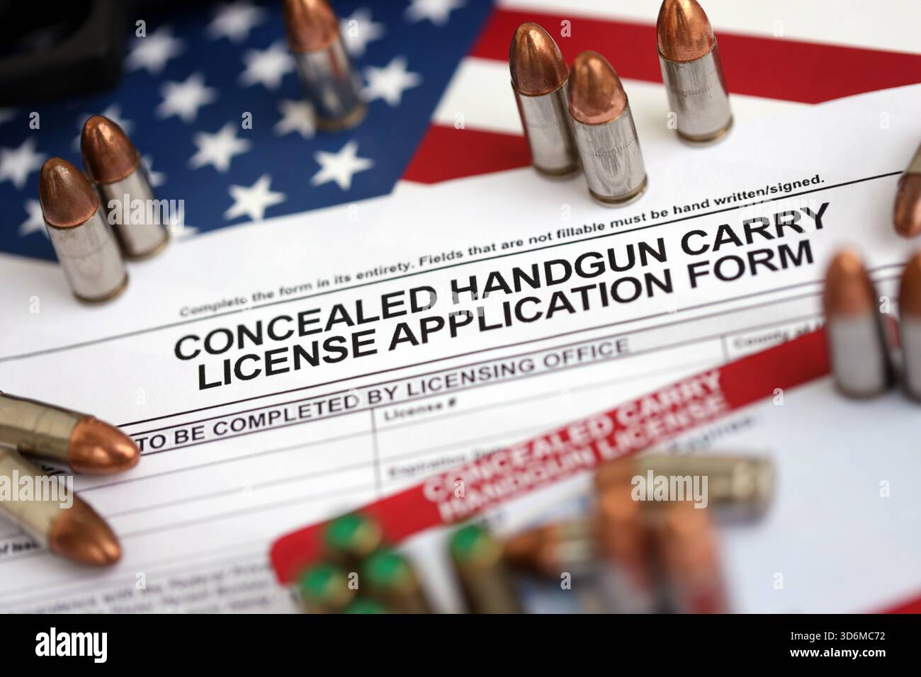 New York firearms license and handgun with bullets on US flag close up ...