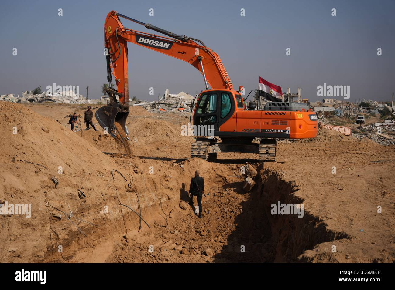Islamic Jihad militants and Egyptian workers search for the bodies of ...