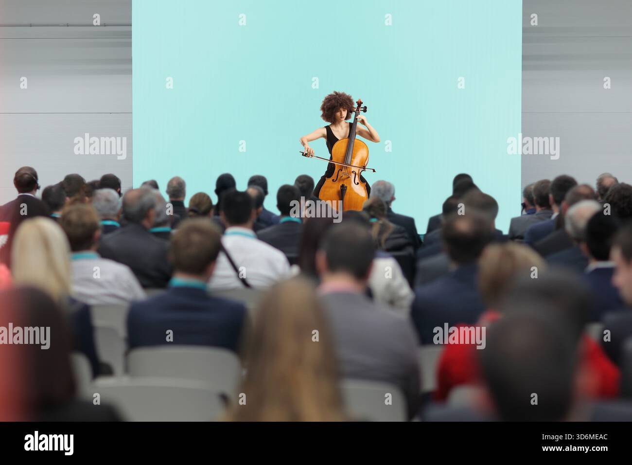 Woman playing a cello in front of audience in a hall Stock Photo - Alamy