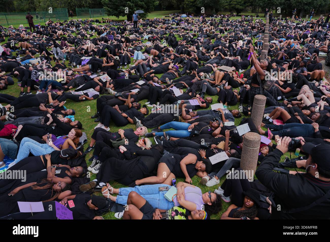 Participants lie on the ground during a gender-based violence protest ...