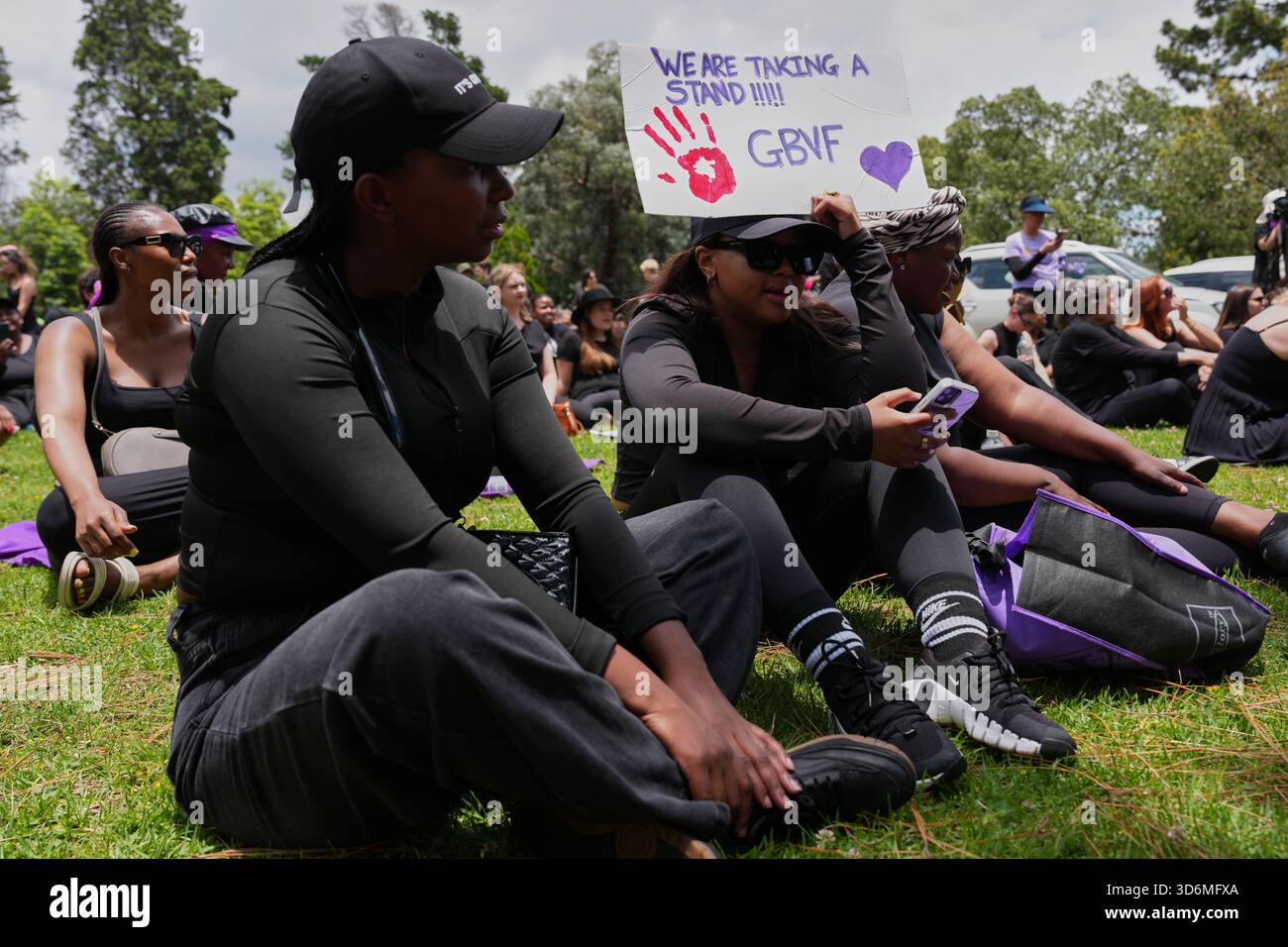 Participants sit together during a gender-based violence protest at the ...