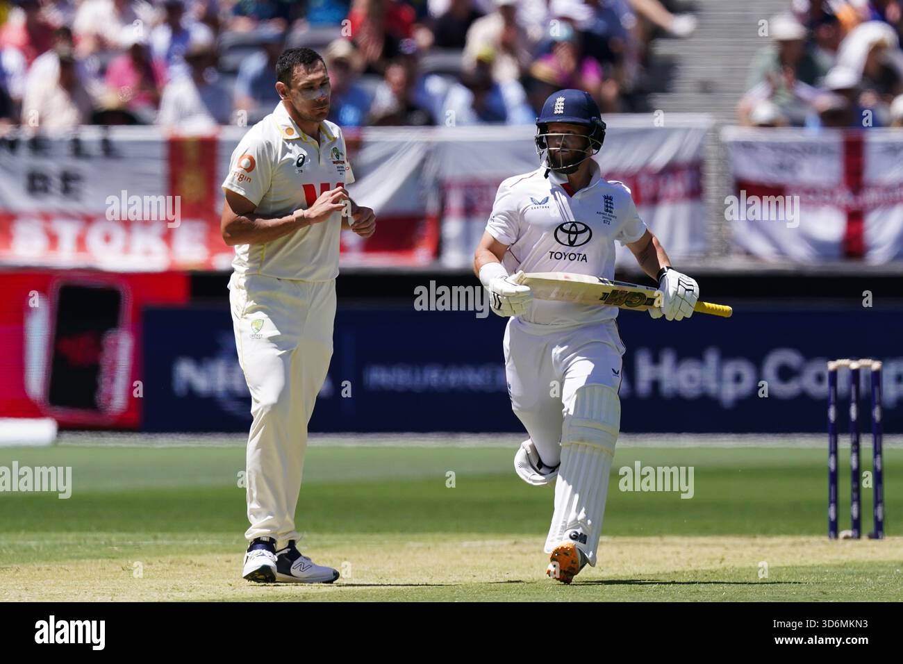 England’s Ben Duckett (right) runs past Australia's Scott Boland (left) on day one of the first ...