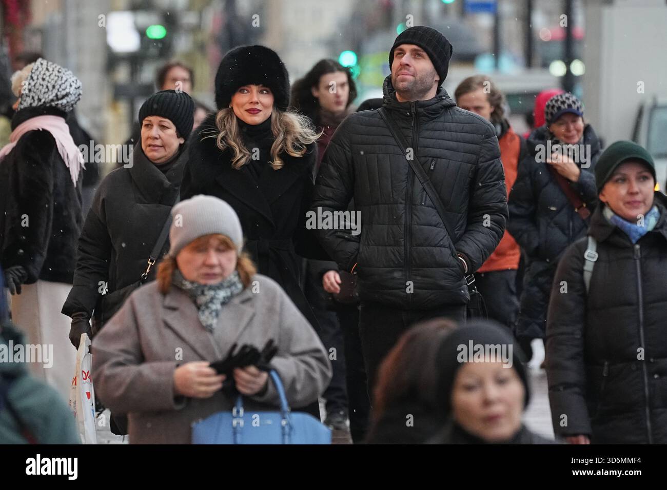 People walk down the street in St. Petersburg, Russia, Friday, Nov. 21 ...