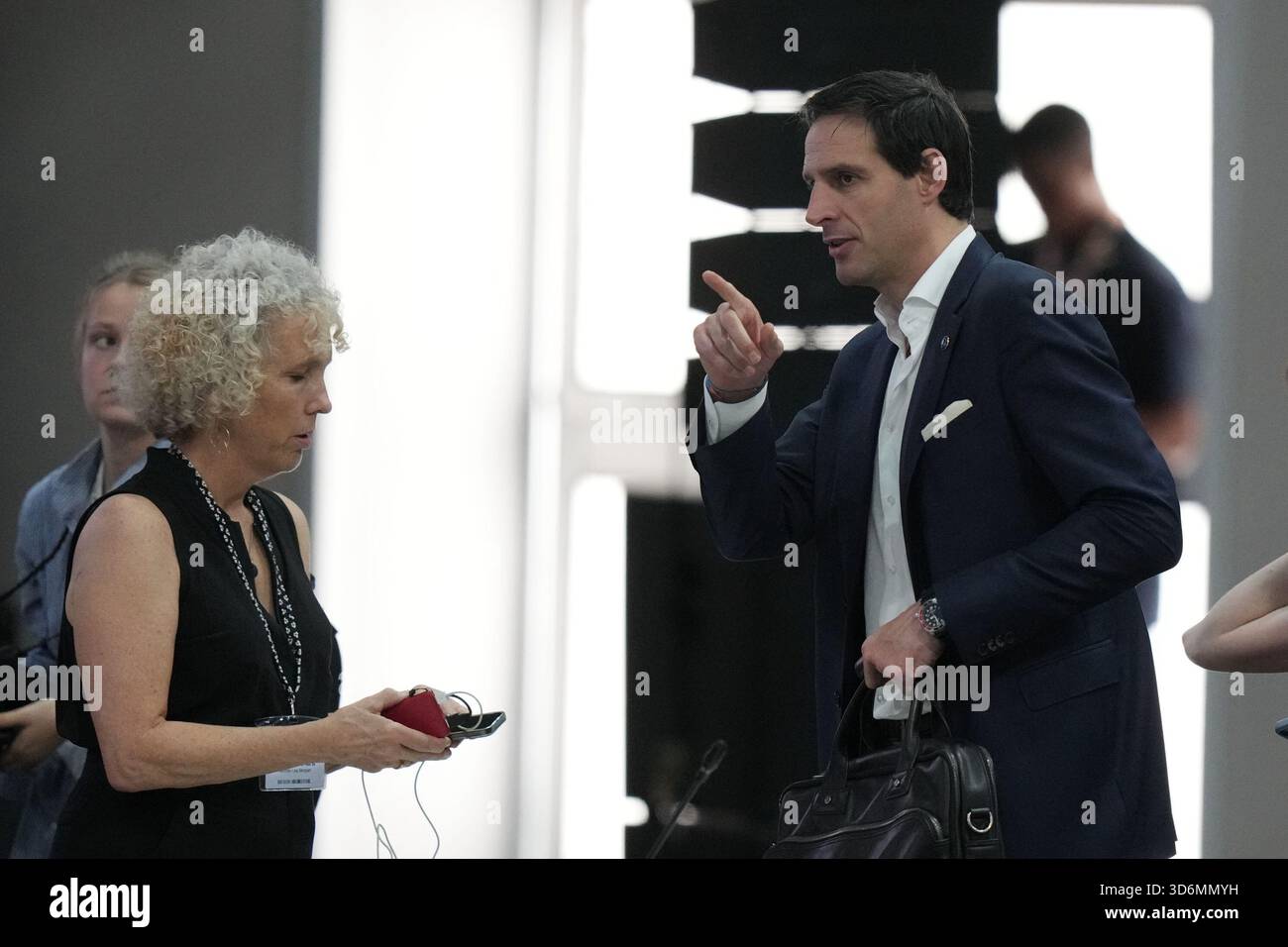 Wopke Hoekstra, EU climate commissioner, right, gestures as he speaks ...