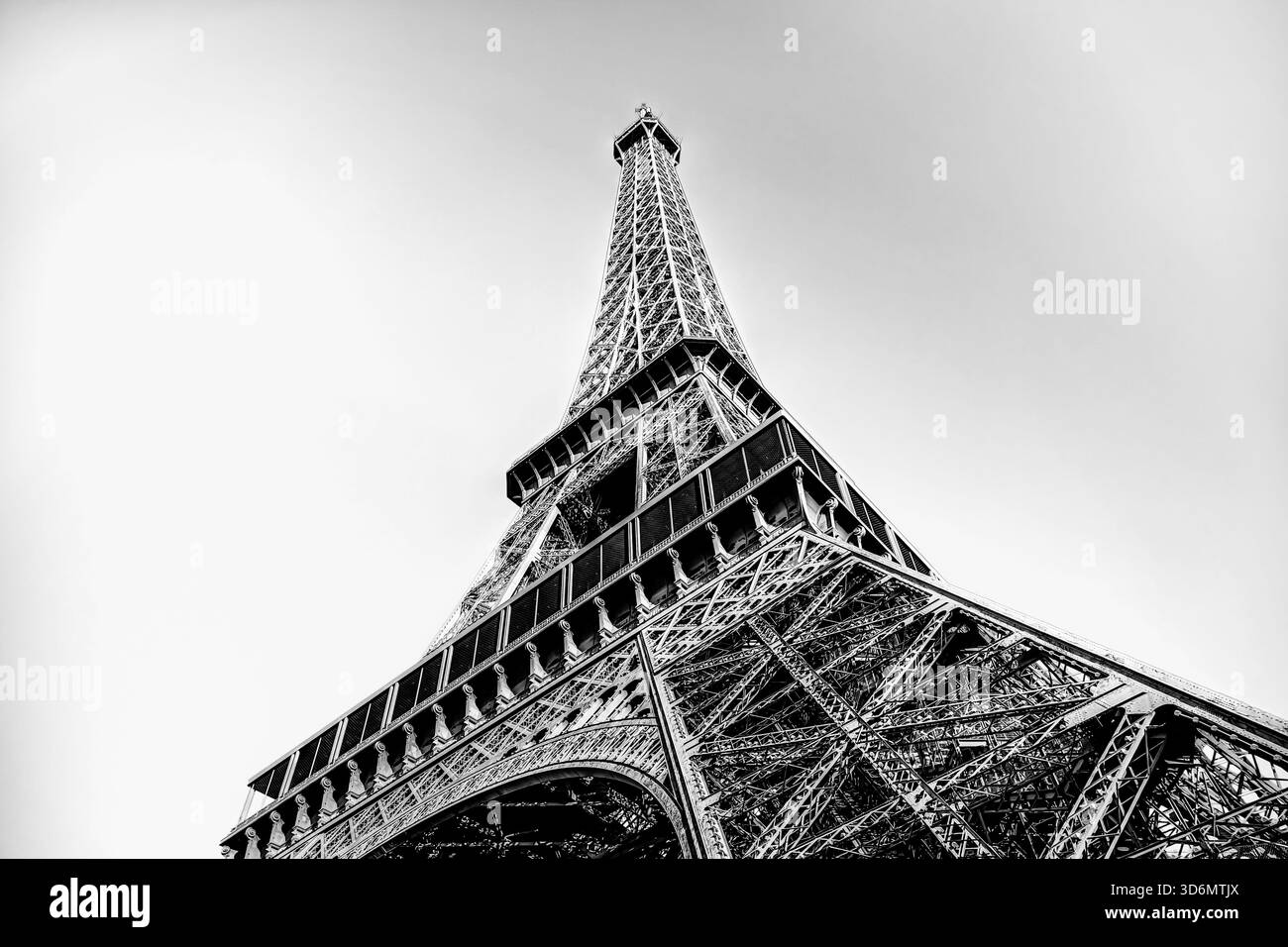Black and white view of the Eiffel Tower’s iron lattice structure from ...