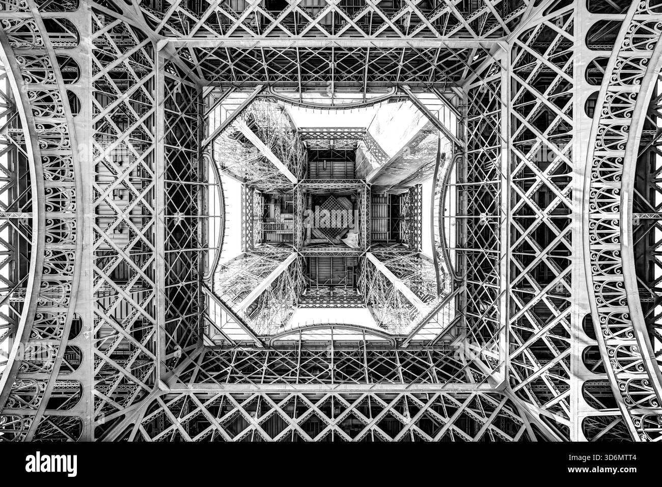 Black and white view of the Eiffel Tower’s iron lattice structure from ...