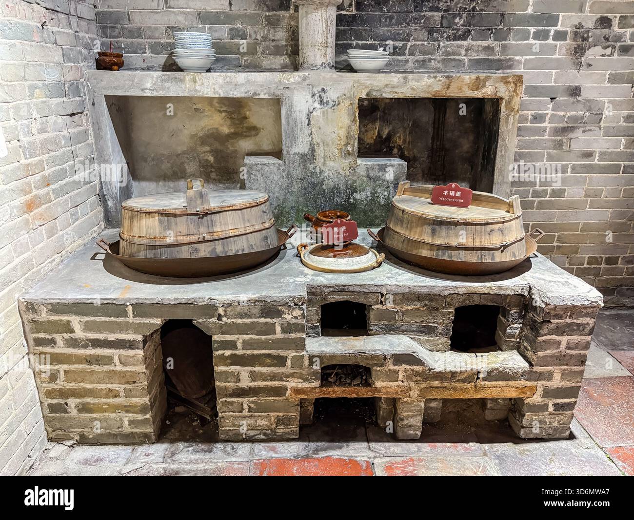 Old wood-burning kitchen replica with brick stove, large wooden pots ...