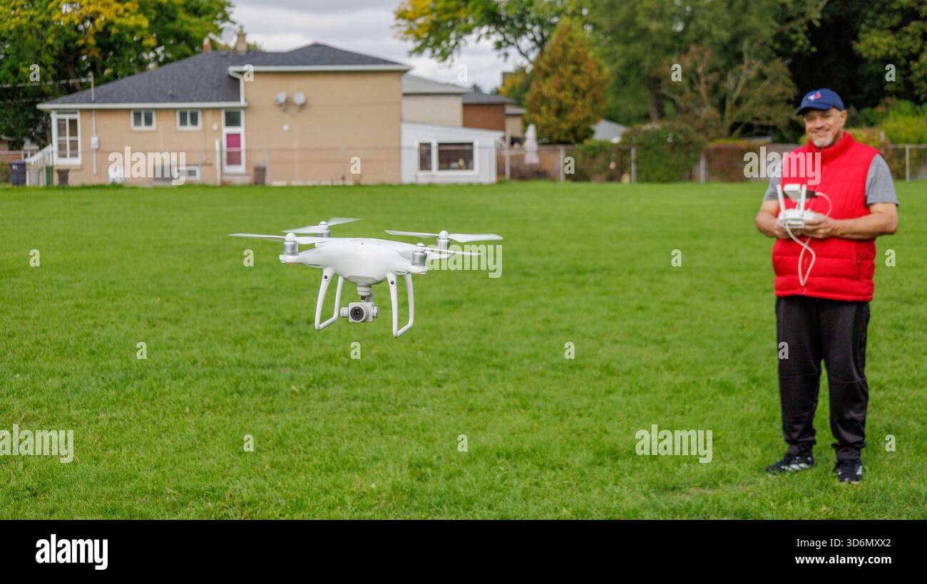 Senior Latin American man working as drone pilot. The device is taking ...