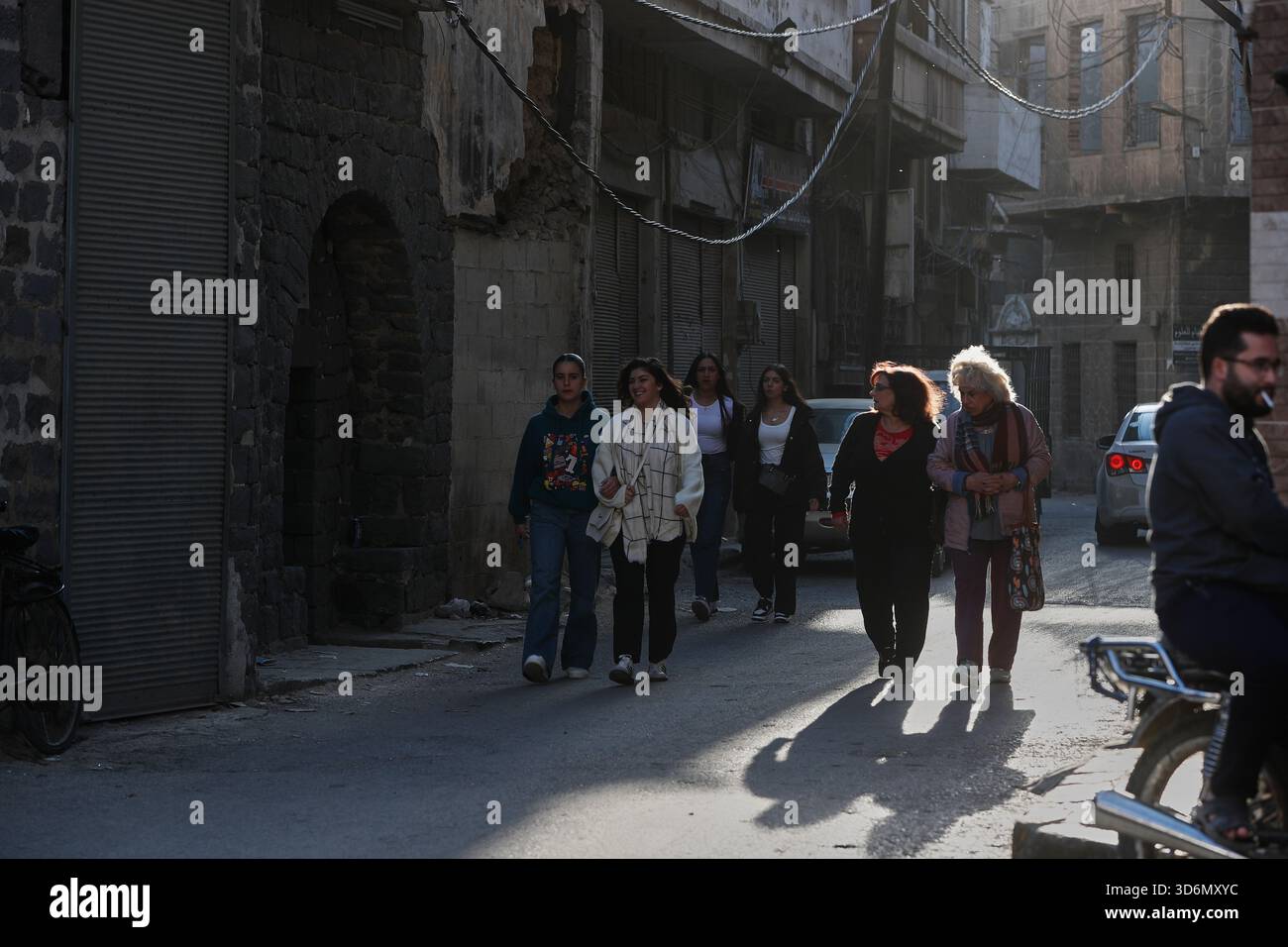People walk through a street in the old city of Homs, Syria, Friday ...