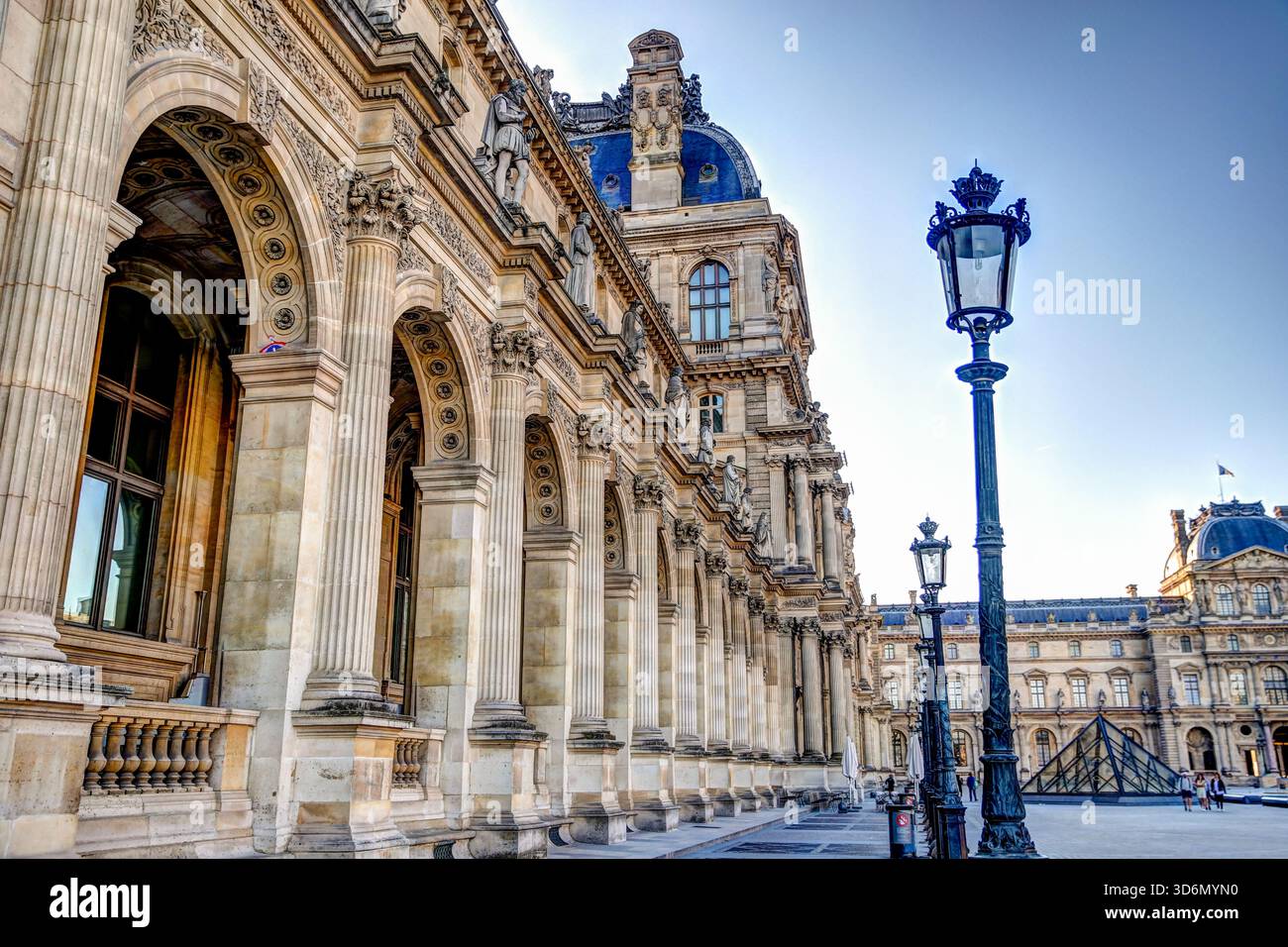 Morning light on the Louvre’s historic stone façade in Paris, showing ...