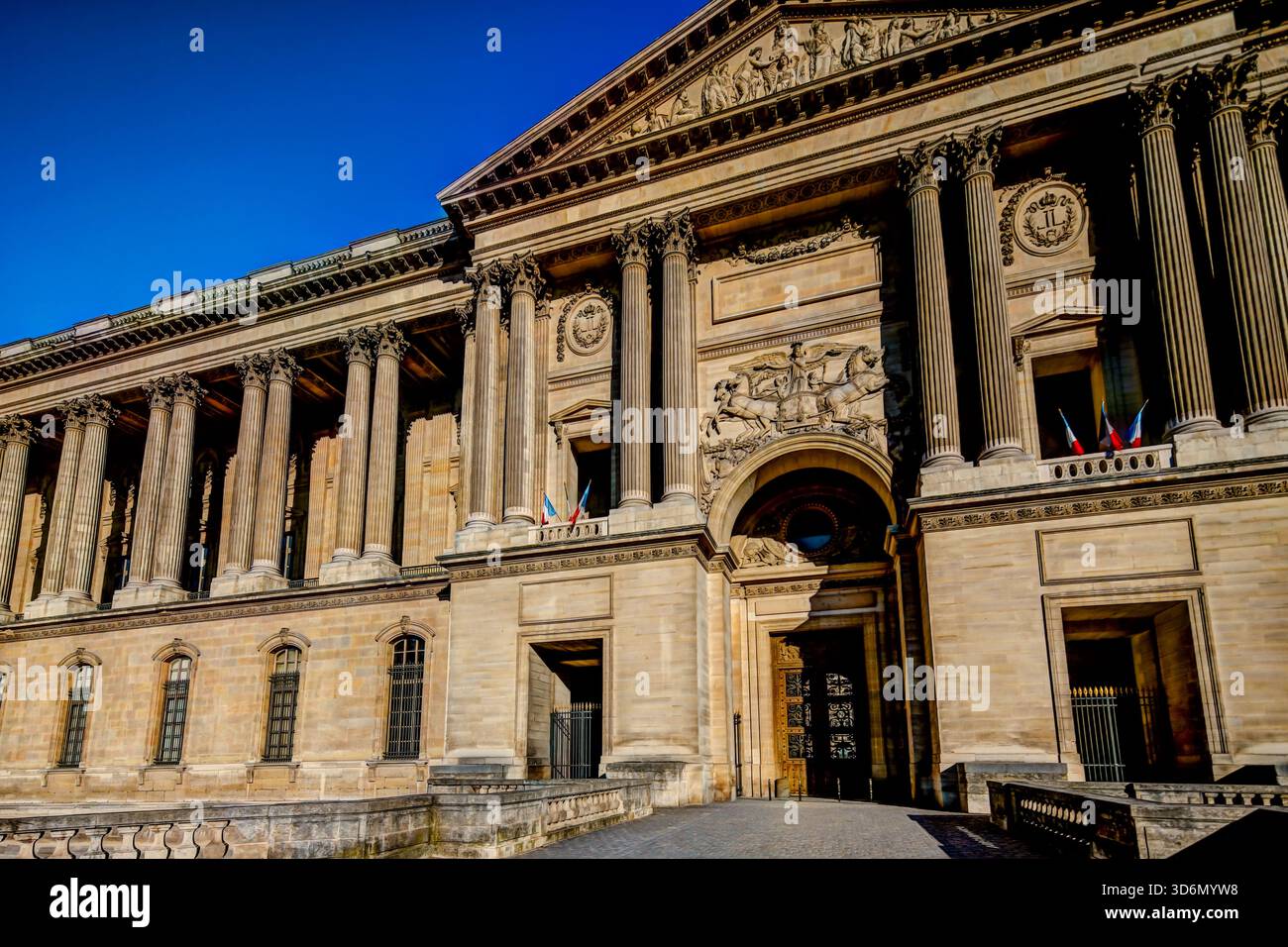 Morning light on the Louvre’s historic stone façade in Paris, showing ...