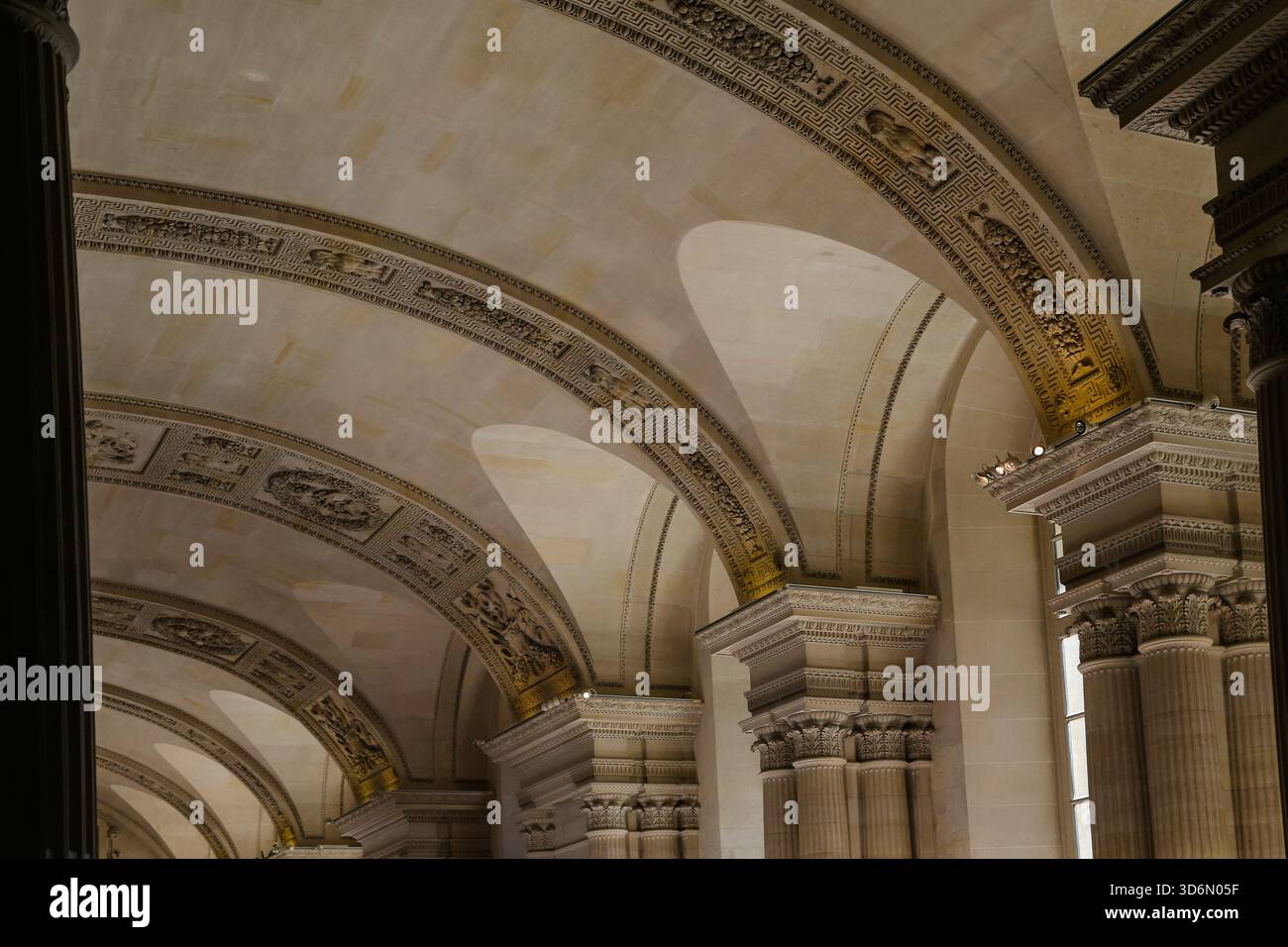 Decorated vaulted arches and columns inside the Louvre Museum in Paris ...