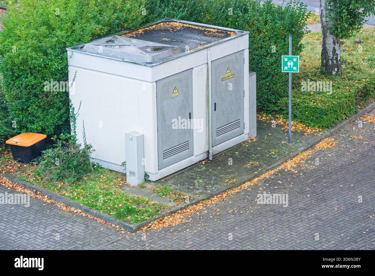 A large transformer cabin stands by the road with a high voltage ...