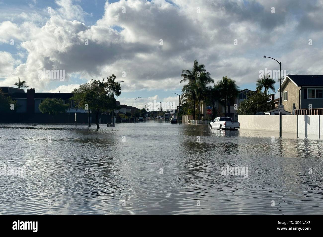 A local pond overflows into a residential neighborhood in Huntington ...