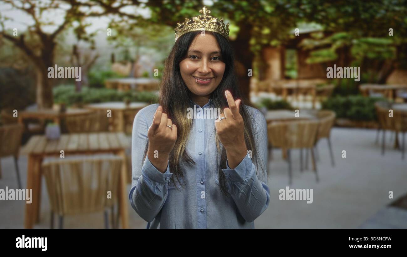 Woman wearing crown making pinched fingers money gesture with hands ...