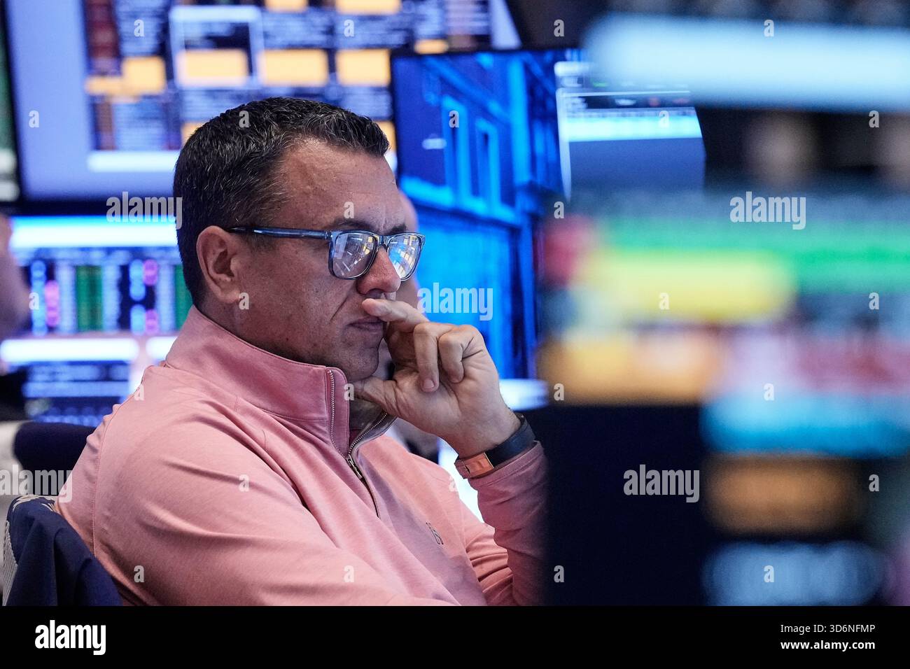 Trader Robert Finnerty Jr. works on the floor of the New York Stock ...