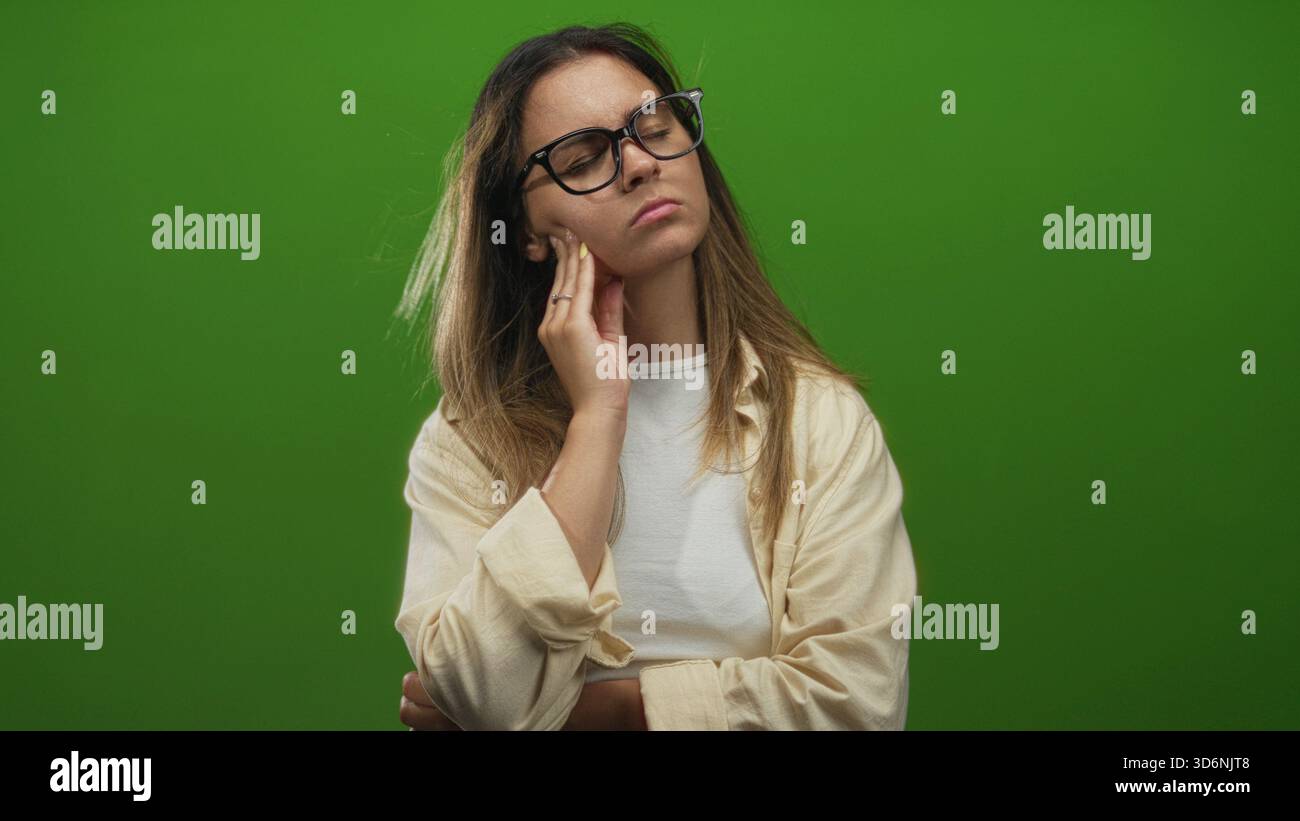 Woman touching cheek squinting wearing hi-res stock photography and ...