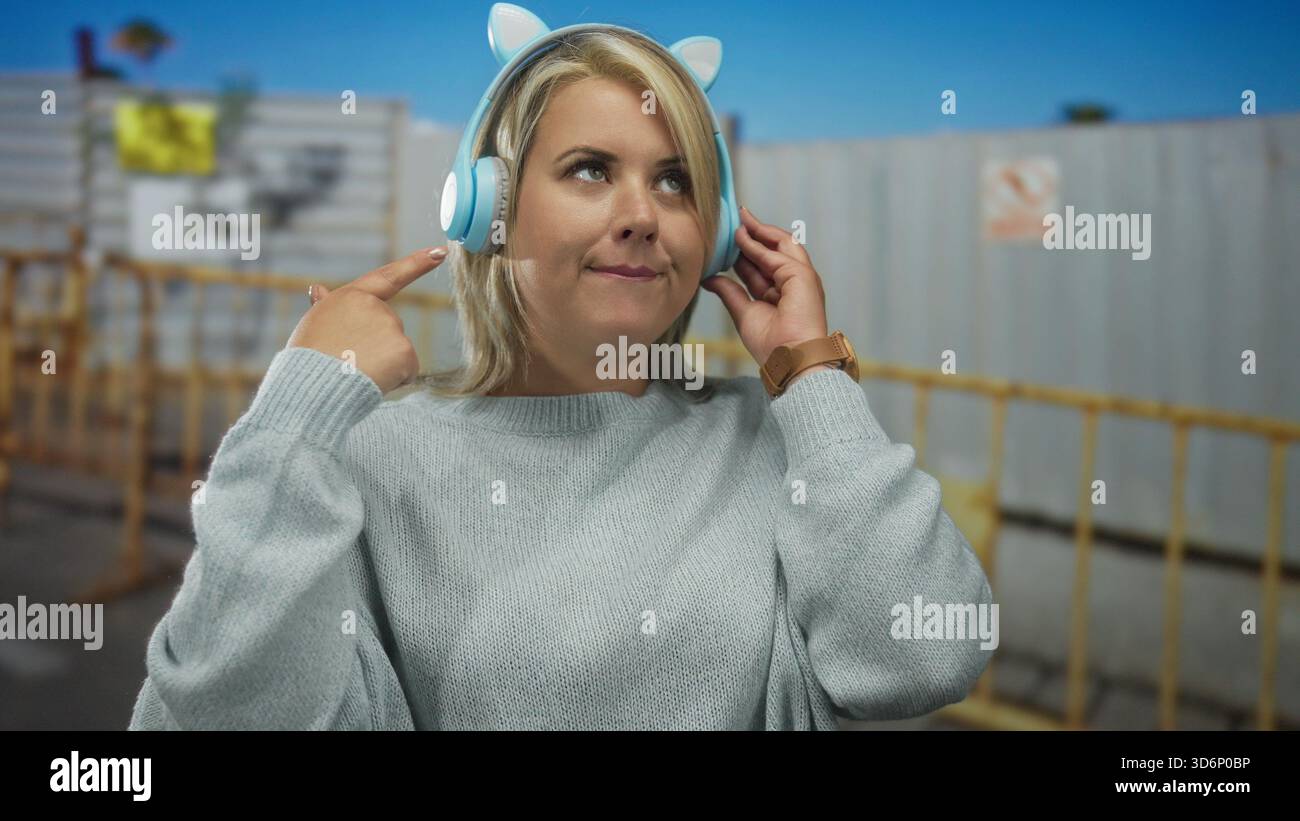 Woman building adjusts headphones hi-res stock photography and images ...