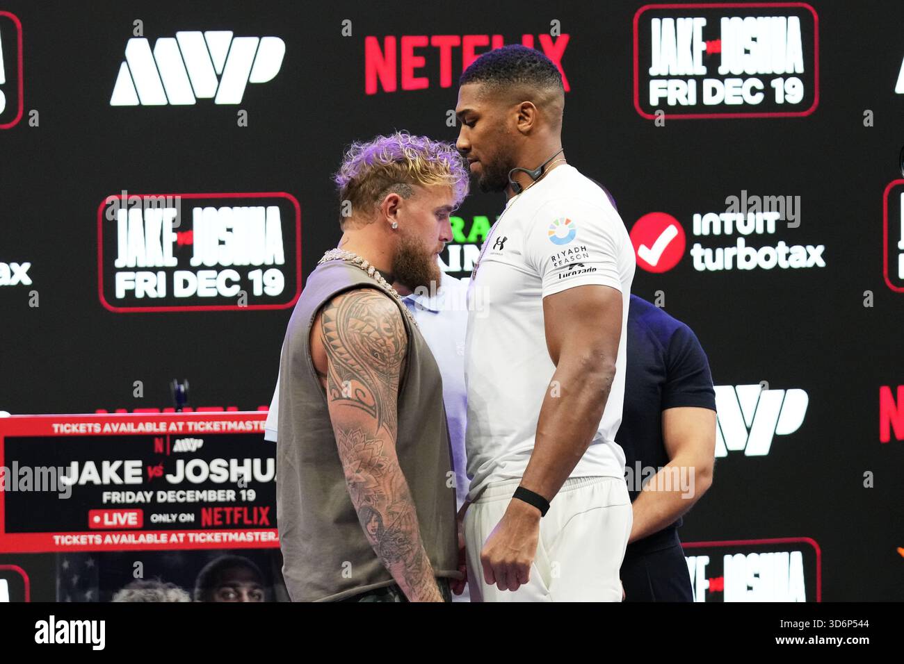 Jake Paul, left, and Anthony Joshua, right, face off during a news ...