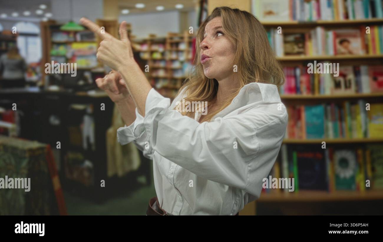 Woman points finger upward and gestures with both hands in building ...