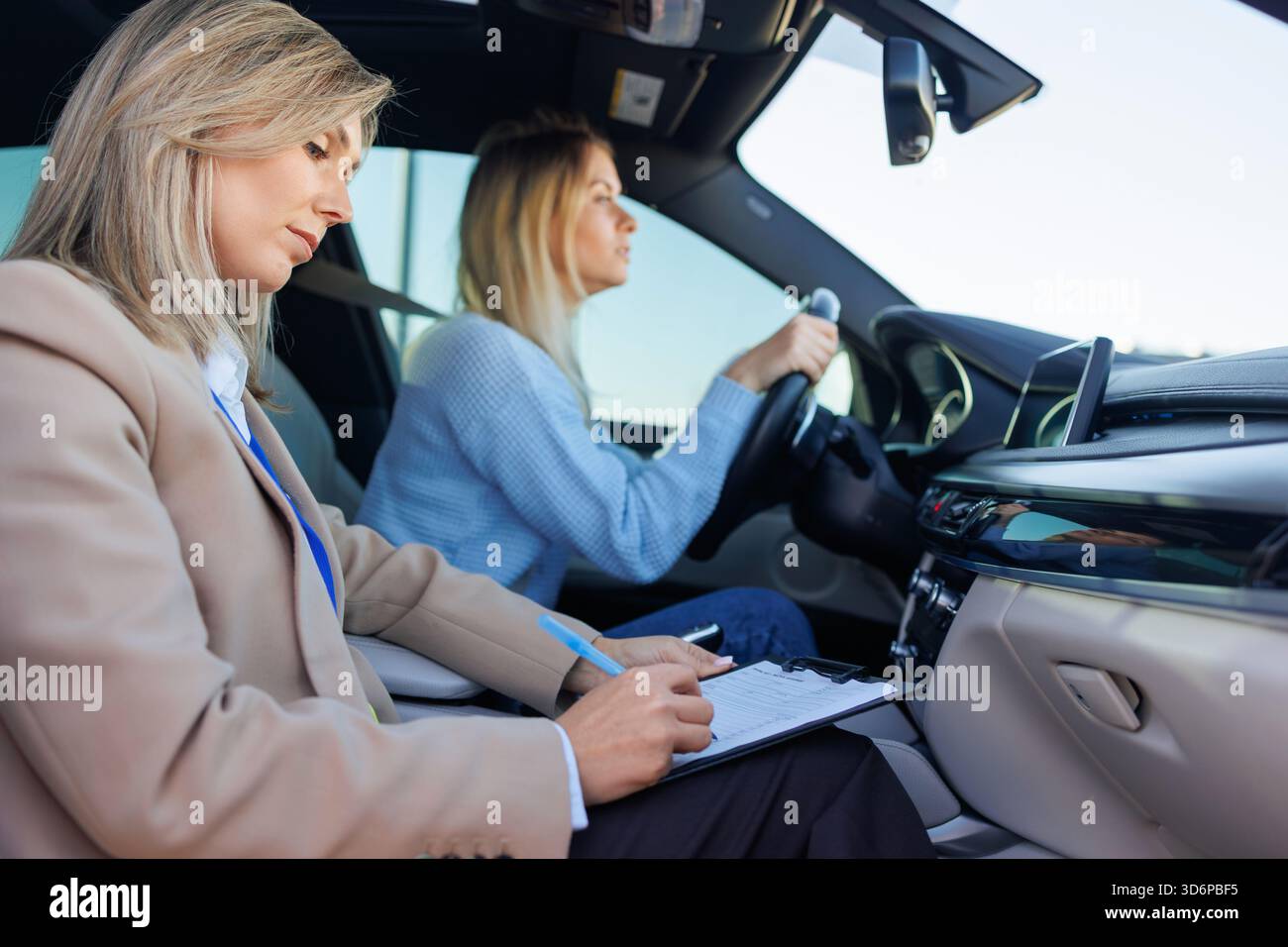 Driving Test Evaluation with Instructor Taking Notes Stock Photo - Alamy