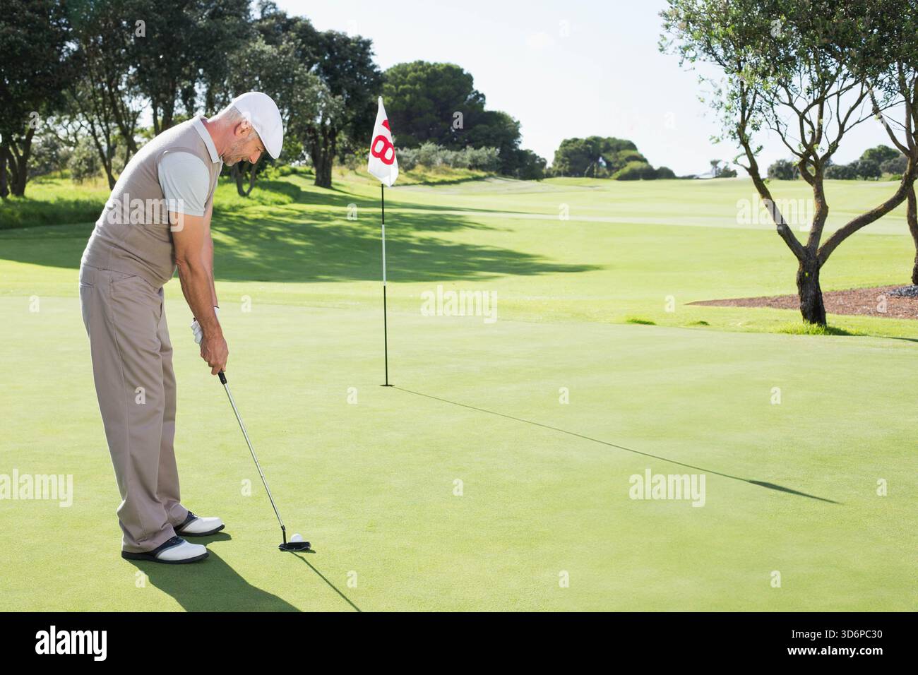 Mature man preparing putt hi-res stock photography and images - Alamy