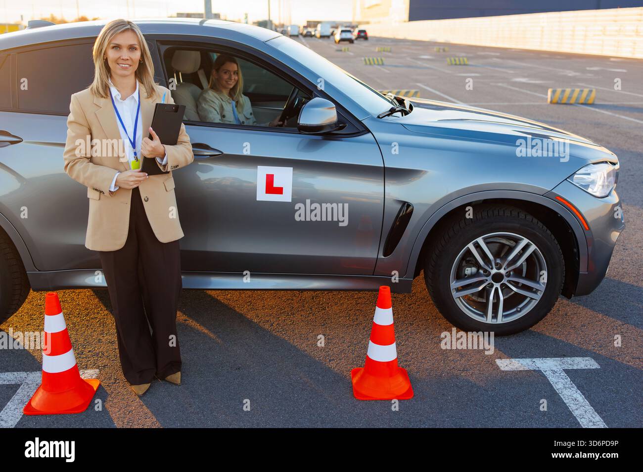 Driving Instructor Standing by Car with Learner Driver After Lesson ...