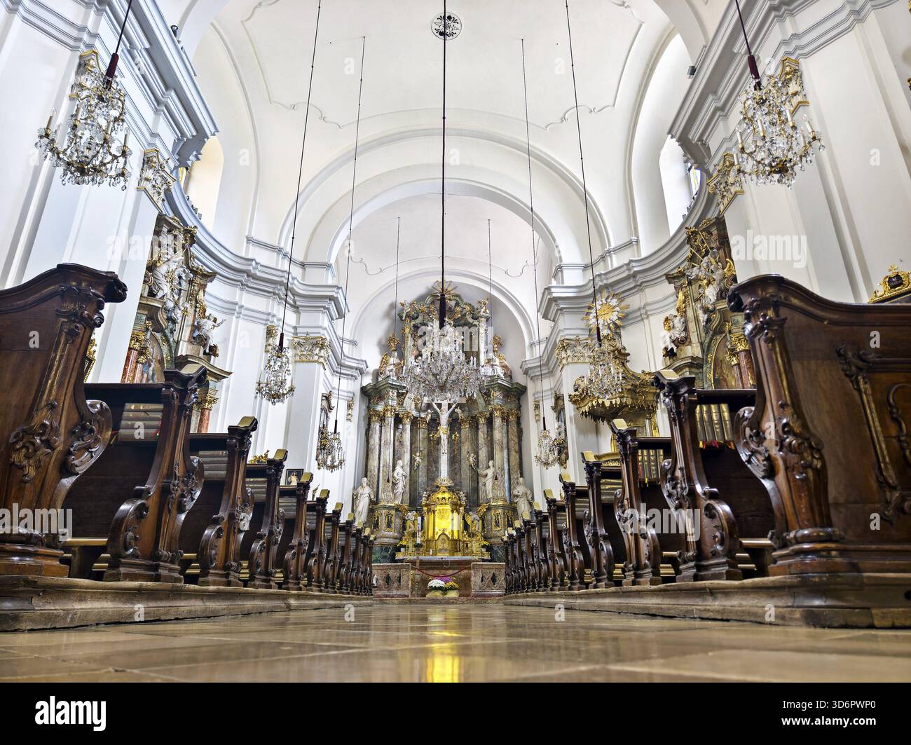Elegant church interior with altar and hanging chandeliers Franciscan ...